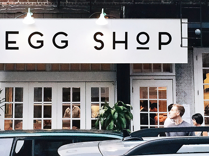The minimalist white storefront of Egg Shop beckons like a breakfast beacon on Elizabeth Street, promising eggy delights within those French doors.