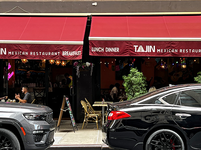 The crimson awning of Tajin beckons like a culinary lighthouse in the urban sea, promising authentic Mexican flavors behind those welcoming doors. 