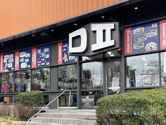 The distinctive orange-trimmed exterior of DII beckons bargain hunters like a retail oasis in Sheepshead Bay, complete with patriotic bunting and clearance promises.