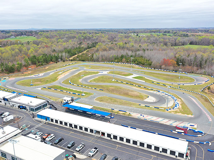 The sprawling track stretches before you like a ribbon of possibility, where everyday drivers transform into racing legends for an afternoon.