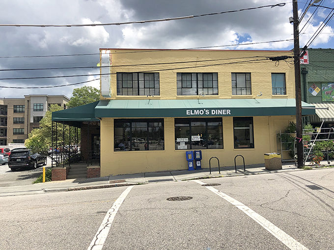 The unassuming yellow exterior of Elmo's Diner stands like a beacon of breakfast hope on Durham's Ninth Street, promising comfort within its walls.