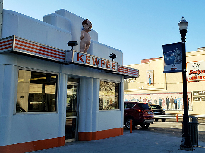 The iconic Kewpee exterior stands like a time capsule of Americana, complete with that watchful doll perched atop like a burger guardian angel.
