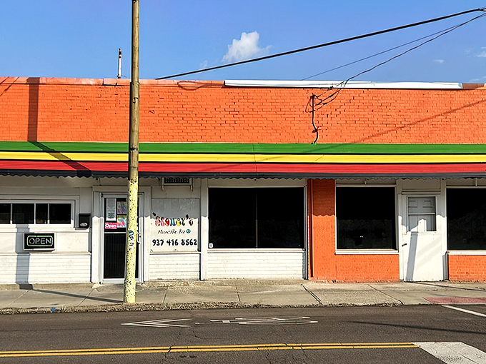 The unassuming brick exterior with its vibrant Jamaican-inspired trim is like a culinary treasure map &ndash; X marks the spot where flavor lives.