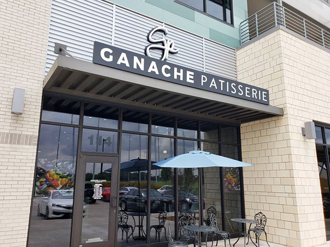 The sleek exterior of Ganache Patisserie promises Parisian delights in Oklahoma City. That blue umbrella beckons like a culinary oasis in the urban landscape.