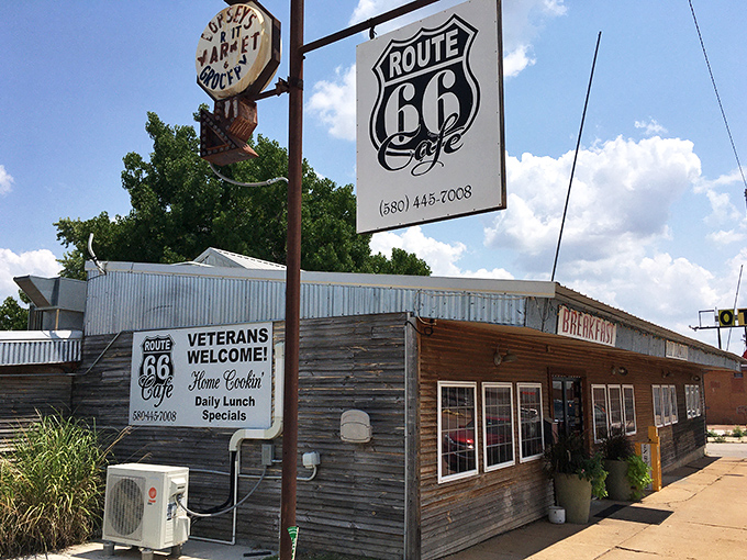 The weathered wooden exterior of Route 66 Cafe stands like a time capsule on Clinton's main drag, beckoning hungry travelers with promises of home cooking and nostalgia.