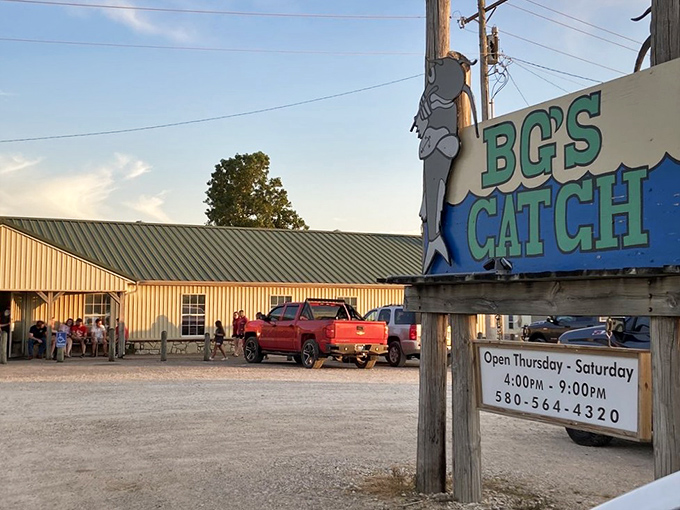 The unassuming exterior of BG's Catch stands like a beacon for hungry travelers, with its iconic fish sign promising seafood salvation in Kingston.