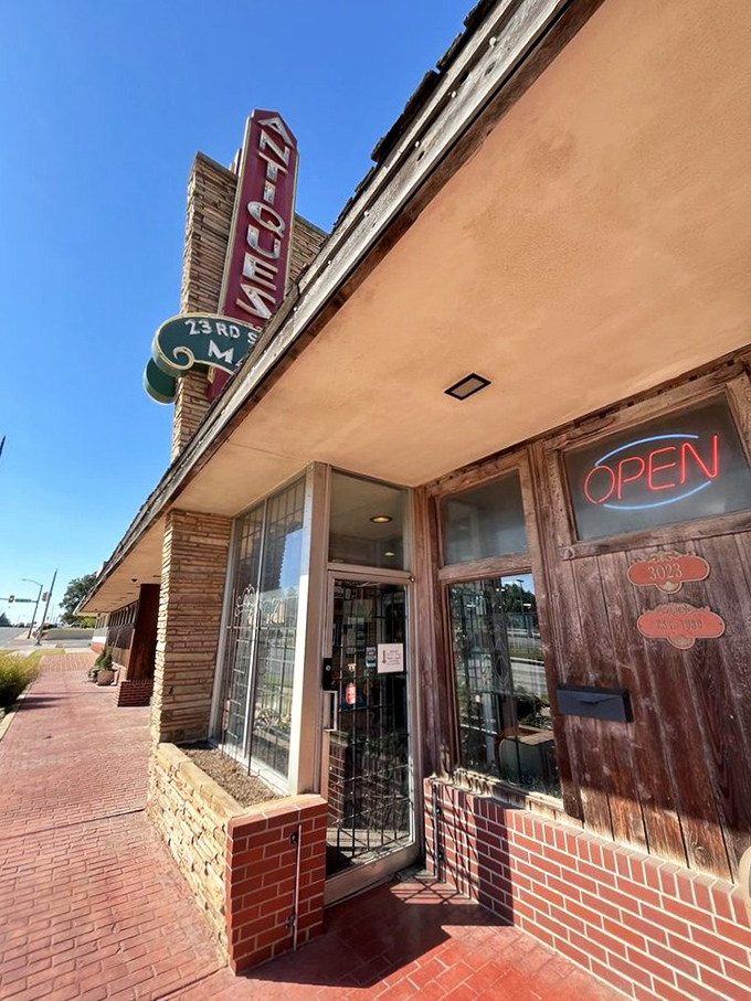 The iconic vintage sign beckons like a time-travel invitation, promising treasures inside this brick building on Oklahoma City's 23rd Street.