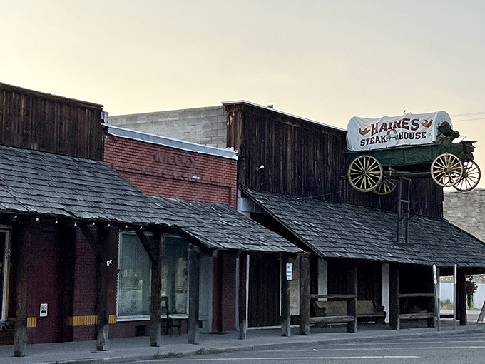 The wagon on the roof isn't just decoration &ndash; it's a beacon for hungry travelers. This rustic wooden exterior promises authentic Western dining experiences inside.