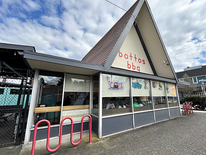 The A-frame architecture of Botto's BBQ stands like a temple to smoked meat perfection, its simple red lettering promising delicious things within.