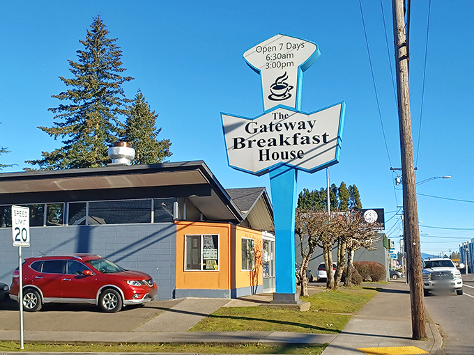 The iconic blue and white arrow sign stands like a beacon of breakfast hope against Portland's famously fickle sky. Classic Americana at its finest.