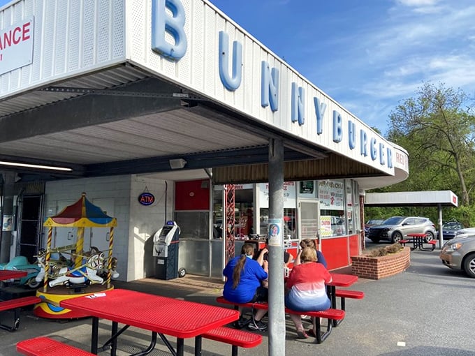 The iconic "Make The Red Rabbit A Habit" sign welcomes hungry travelers like a beacon of burger salvation on Route 322. Nostalgia never tasted so good. 
