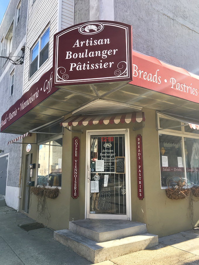 The charming exterior of Artisan Boulanger Patissier beckons from its South Philly corner, promising French delights behind that unassuming burgundy awning. 