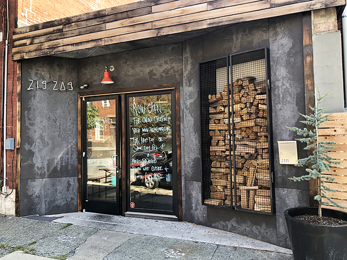 The industrial-chic exterior with its caged firewood display isn't just Instagram bait&mdash;it's a smoky promise of what awaits inside. Meat destiny calls. 