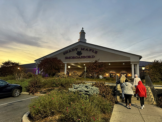 The iconic white facade of Shady Maple welcomes hungry pilgrims at sunset, promising a Pennsylvania Dutch feast that's worth every mile of the journey. 