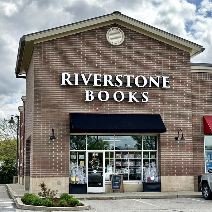 The brick fa&ccedil;ade of Riverstone Books stands like a literary lighthouse, beckoning bibliophiles with its simple, elegant signage against the blue Pittsburgh sky. 