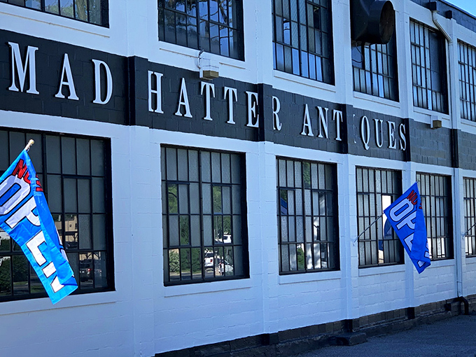 A classic red Volkswagen Beetle parked outside Mad Hatter's striking white facade&mdash;like a cherry on top of this multi-layered sundae of nostalgia. 
