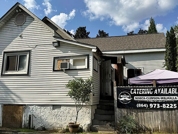 That iconic mustache sign against white clapboard siding says it all: unpretentious exterior, extraordinary flavors waiting inside.