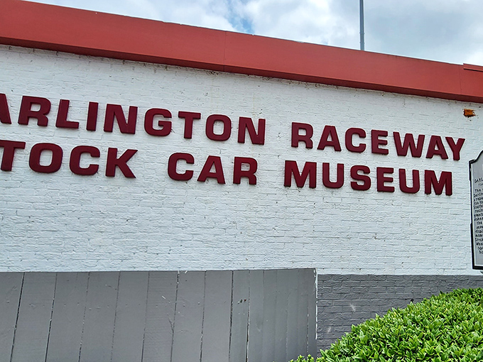 The unassuming white brick facade belies the treasures within, like finding a five-star restaurant in a gas station. Racing history awaits!
