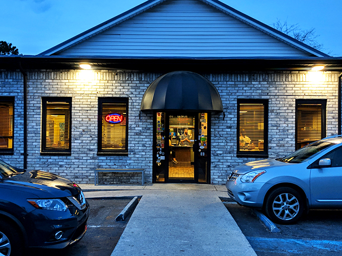 The colorful exterior of Early Bird Diner stands out like a beach umbrella in winter, promising a dining experience as vibrant as its paint job. 