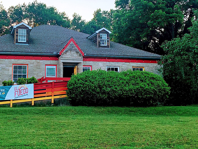 El Fuego's stone exterior with vibrant red trim stands out like a culinary lighthouse, beckoning hungry travelers with promises of authentic Mexican flavors.
