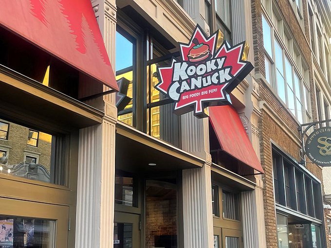 The iconic maple leaf sign beckons hungry adventurers to Kooky Canuck, where Canadian charm meets Memphis hospitality on downtown's bustling streets.