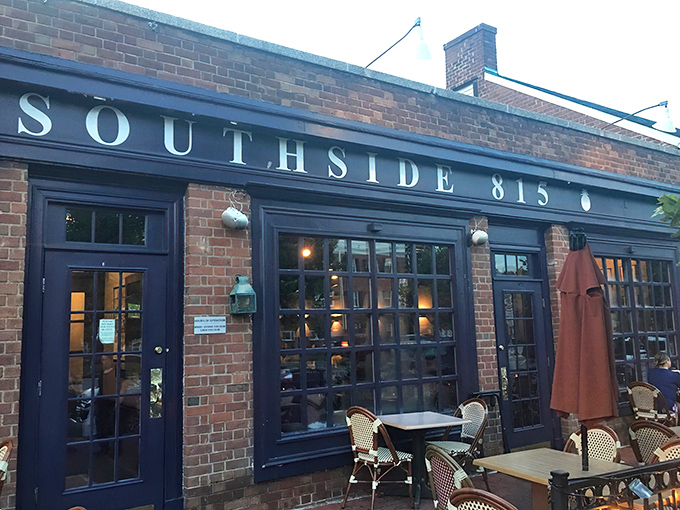 The inviting brick exterior of Southside 815 with its navy blue awning and charming patio seating beckons hungry travelers like a Southern lighthouse. 