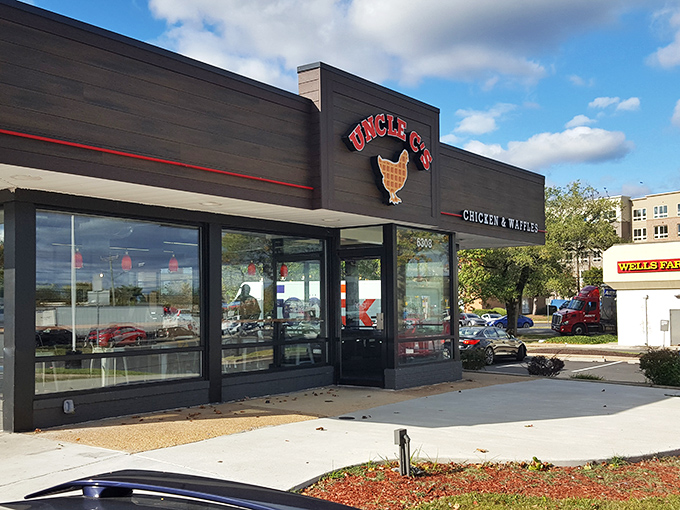 The glowing sign of Uncle C's beckons hungry travelers like a lighthouse for the famished. Modern exterior with classic comfort food promise.