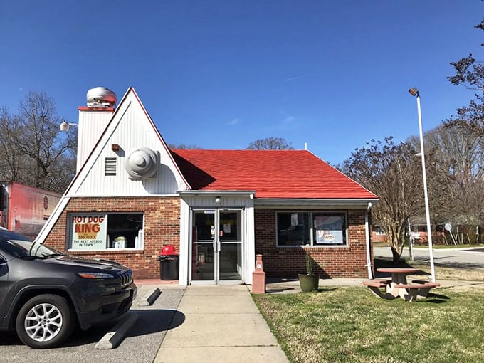 The iconic yellow sign of Gus's Hot Dog King stands like a beacon of comfort food against the Virginia sky, promising Hormel hot dogs and memories in equal measure.