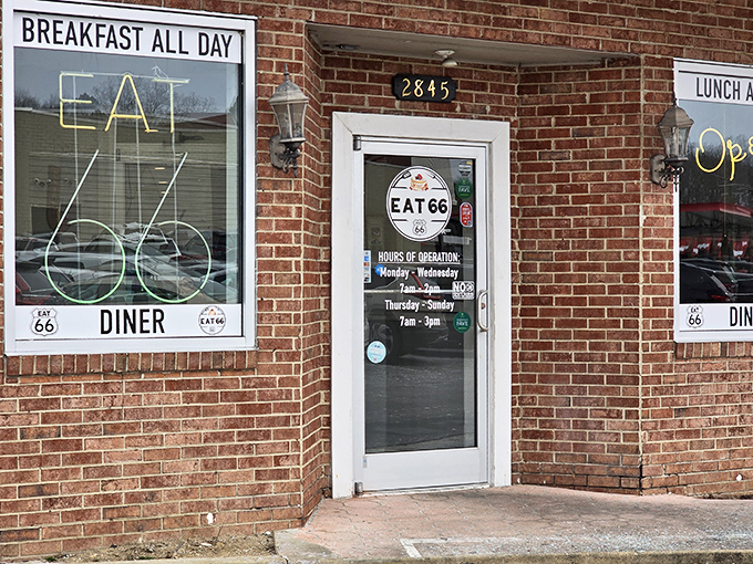 The brick facade of Eat 66 beckons like a time portal to simpler days, when "breakfast all day" was the sweetest promise a neon sign could make.