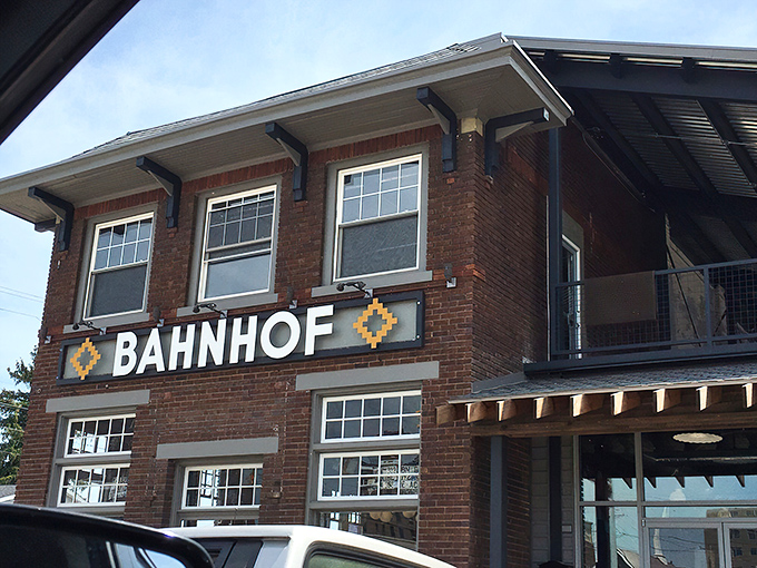 The brick facade of Bahnhof WVrsthaus & Biergarten stands proudly in Huntington, with that giant pretzel sculpture practically winking at hungry passersby.