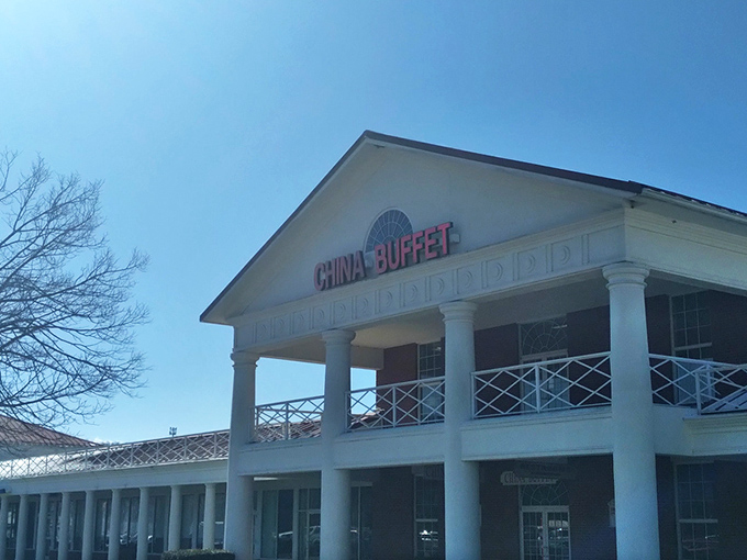 The stately white columns of China Buffet stand proudly against the blue sky, like a temple dedicated to the worship of all-you-can-eat delights.