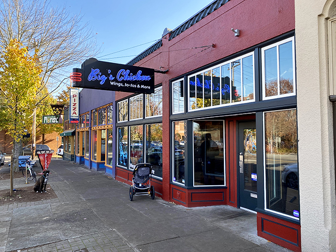 The vibrant red exterior with bright blue signage isn't just eye-catching&mdash;it's a beacon for chicken lovers seeking Portland's crispiest treasures. 