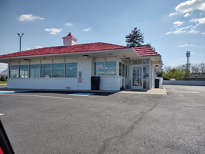 The unassuming white building with its cherry-red roof stands like a beacon of hope for hungry travelers. Culinary treasures often hide in plain sight. 