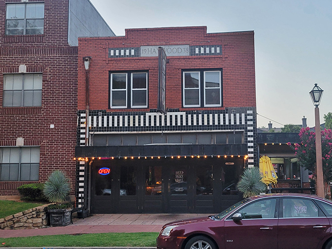The iconic Deep Deuce Grill sign beckons hungry travelers like a lighthouse for comfort food. Those string lights aren't just decoration&mdash;they're a promise of good things to come.