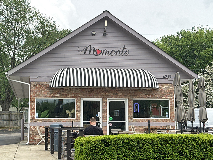 A brick cottage with a striped awning that whispers, "Come inside, we've got something special brewing." This charming exterior hides Tennessee's best-kept breakfast secret.