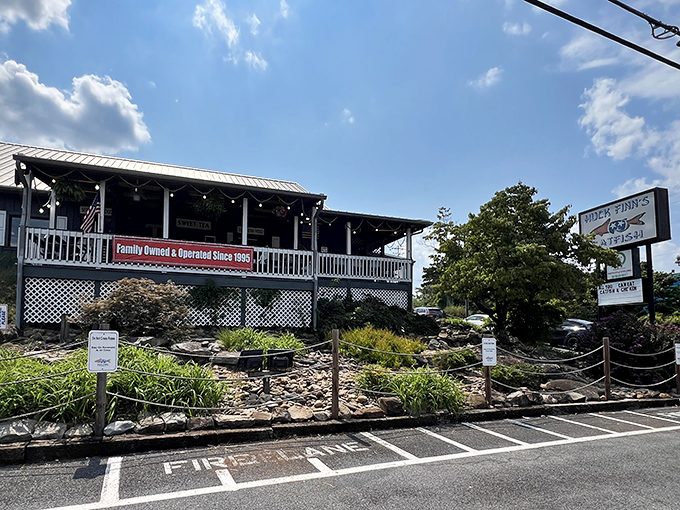 The unassuming exterior of Huck Finn's Catfish stands like a humble guardian of flavor, promising Southern comfort beneath its metal roof and welcoming porch.
