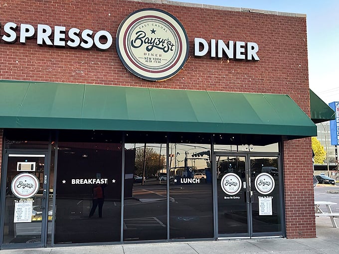 The brick facade with teal awnings isn't just inviting&mdash;it's practically shouting "Come get breakfast!" Those white picnic tables are waiting for your morning revelation.