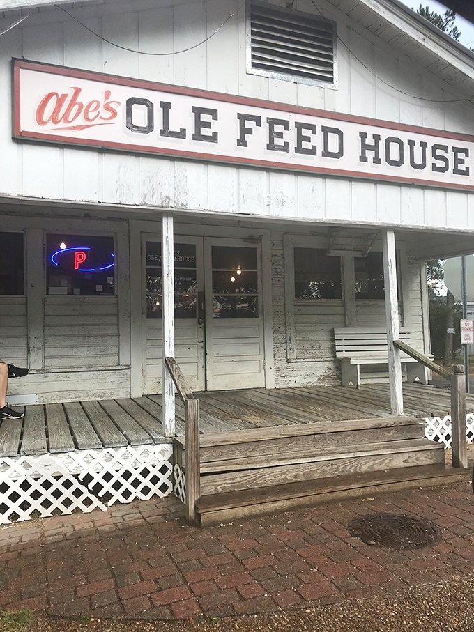 The unassuming exterior of Abe's Ole Feed House stands like a time capsule of Southern hospitality, complete with porch swing for pre-feast contemplation.
