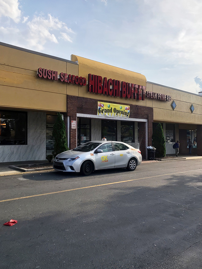 The golden-yellow exterior of Hibachi Buffet beckons like a beacon of culinary abundance on Buford Highway, with its bold red lettering promising seafood, steak, and prime rib adventures within.