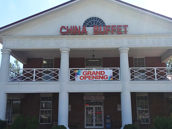 The stately white columns of China Buffet stand proudly against the blue sky, like a temple dedicated to the worship of all-you-can-eat delights.