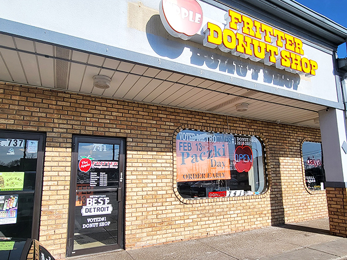 The yellow block letters against brick might not scream "culinary destination," but locals know this humble storefront houses donut royalty.