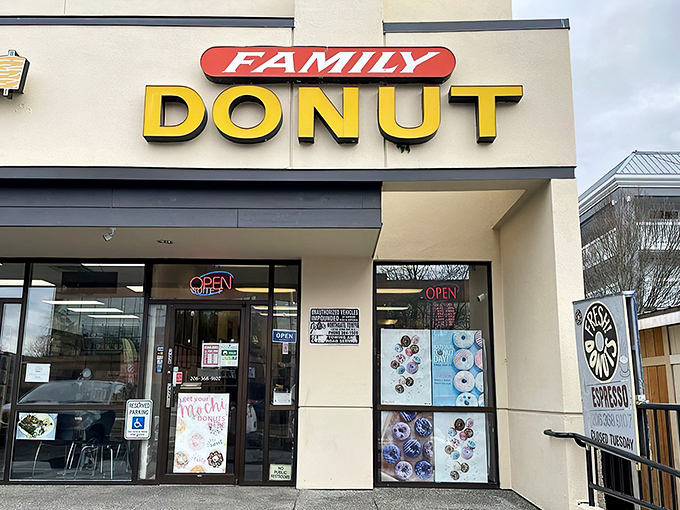 The yellow "DONUT" sign beckons like a lighthouse guiding sugar-seeking ships through morning fog. This unassuming storefront holds Seattle's sweetest treasures. 