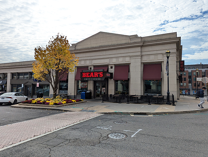 The stone facade of Bear's Smokehouse stands like a temple to barbecue, its bold red sign a beacon to hungry pilgrims seeking smoky salvation.