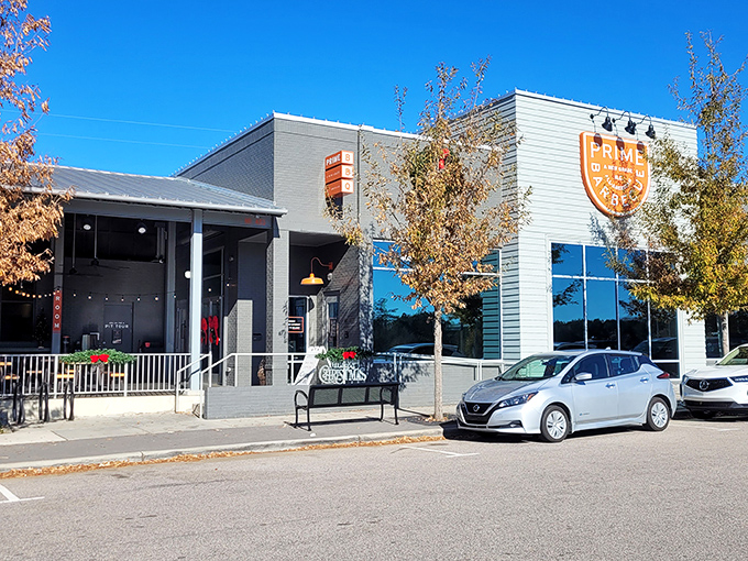Modern meets mouthwatering at Prime Barbecue's sleek Knightdale exterior. The orange shield logo beckons like a barbecue bat-signal to hungry heroes everywhere.