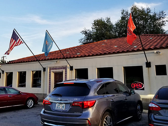 Three flags flutter proudly outside this unassuming barbecue sanctuary, where the red tile roof and stucco walls hide smoky treasures within.