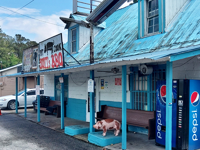 The pilgrimage destination itself: Scott's Bar-B-Que stands proudly with its metal roof and blue-trimmed exterior, a humble temple to smoked meat perfection.