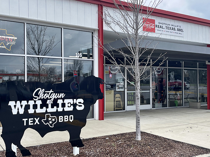 The iconic black cow sign stands guard outside this unassuming strip mall location, promising Texas-sized flavor inside.