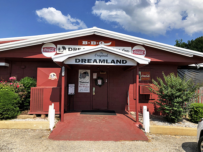 The unassuming red exterior of Dreamland BBQ stands like a barbecue beacon in Tuscaloosa. No fancy frills needed when what's inside speaks volumes through smoke signals.
