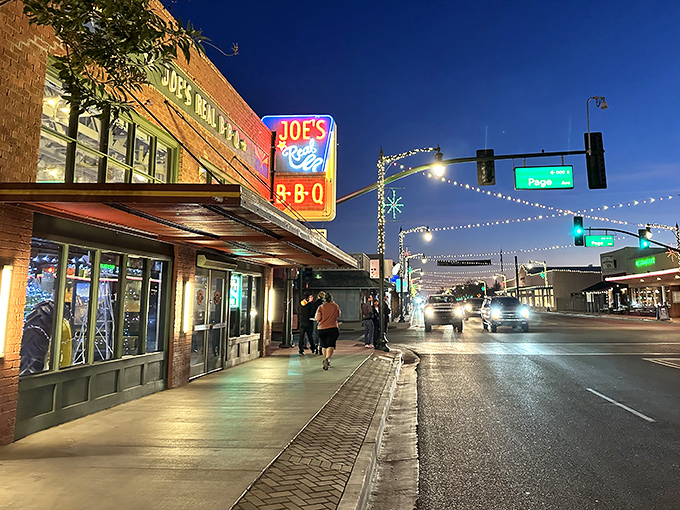 The brick fortress of flavor stands proudly on Gilbert's corner, its Arizona flag-adorned sign promising smoky treasures within. A barbecue beacon in the desert.