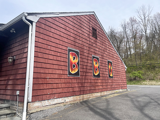 The unassuming red exterior hides barbecue greatness like Clark Kent's glasses hide Superman. That "OPEN" sign is your beacon to smoky paradise.